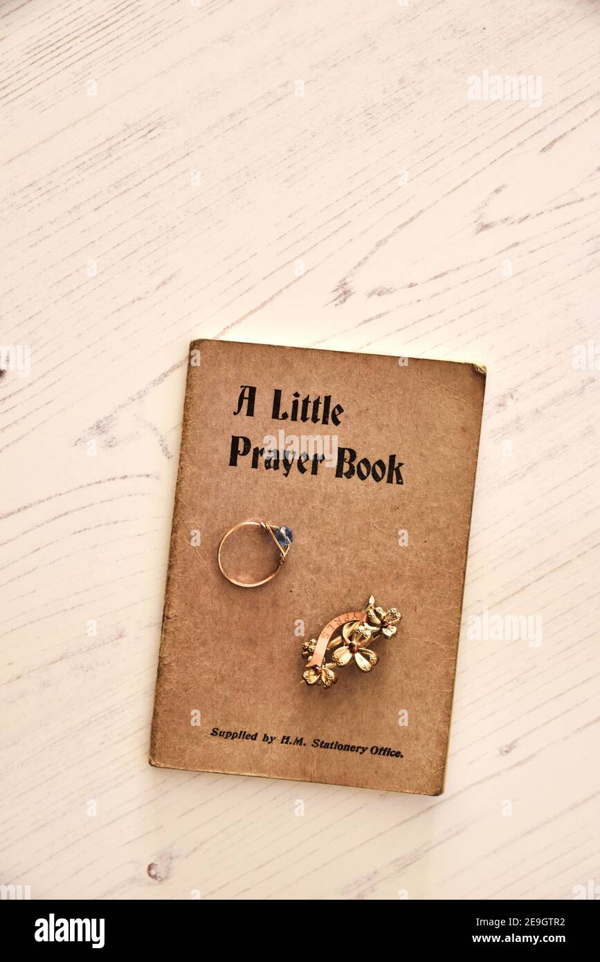 Ring and brooch showing Ypres on top of First World War prayer book ...