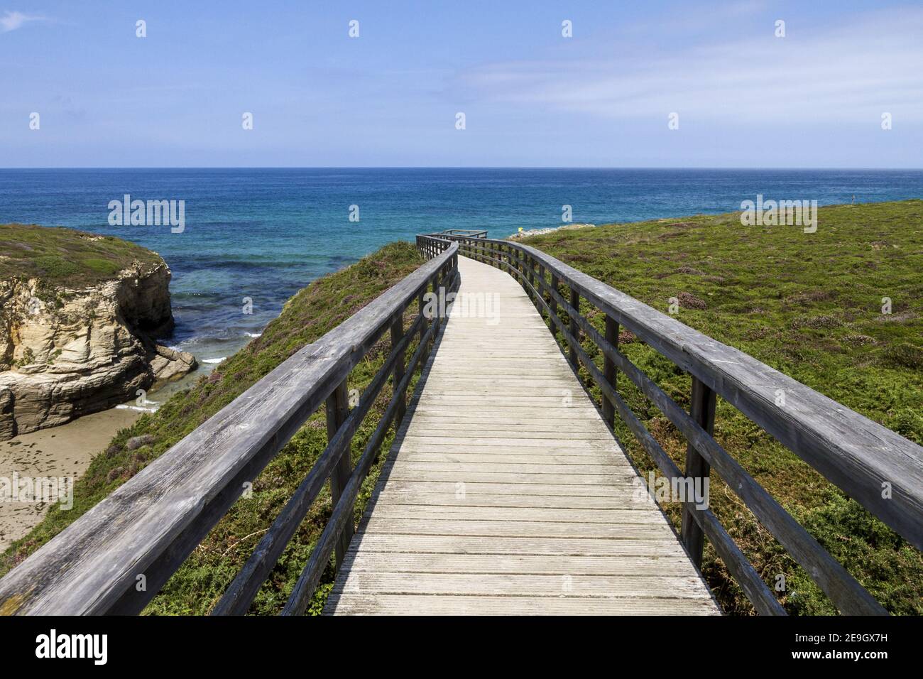 Pier bridge at the shore washed by blue ocean waves Stock Photo - Alamy
