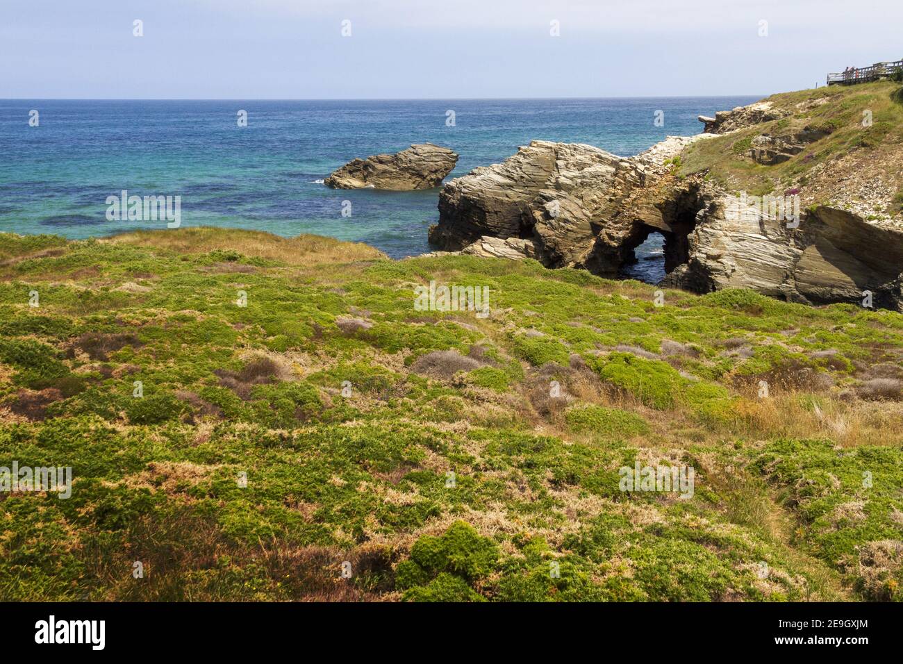 Stone shore at the beach washed by blue ocean waves Stock Photo - Alamy
