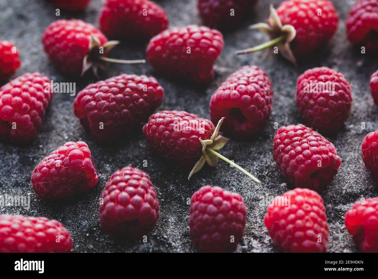 Raspberries food background - ripe harvested raspberry arranged on gray ...
