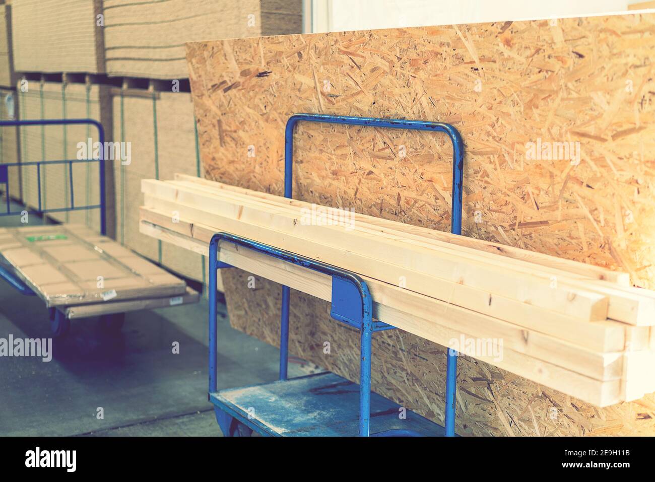 Trolley in a hardware store with building materials. Warehouse large ...