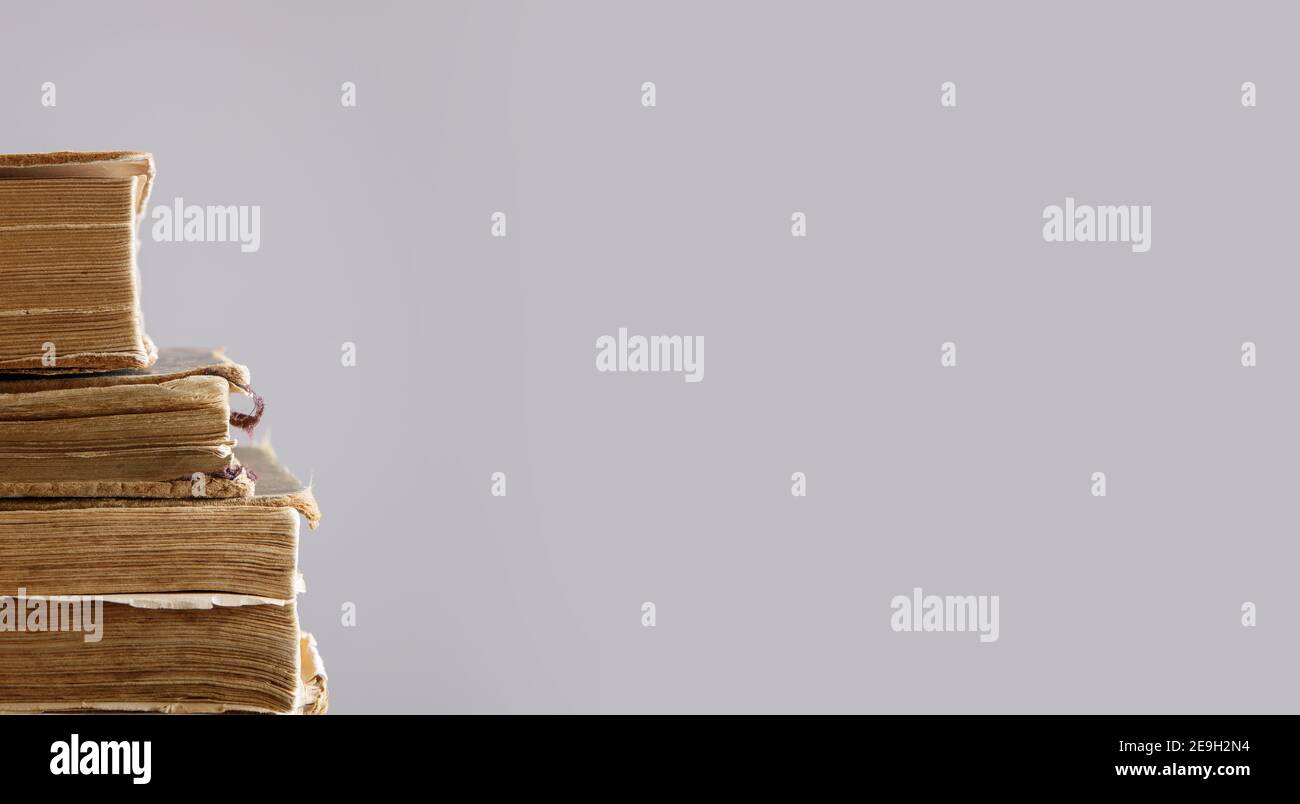 jagged corner of old books with brown textured paper and torn cover ...