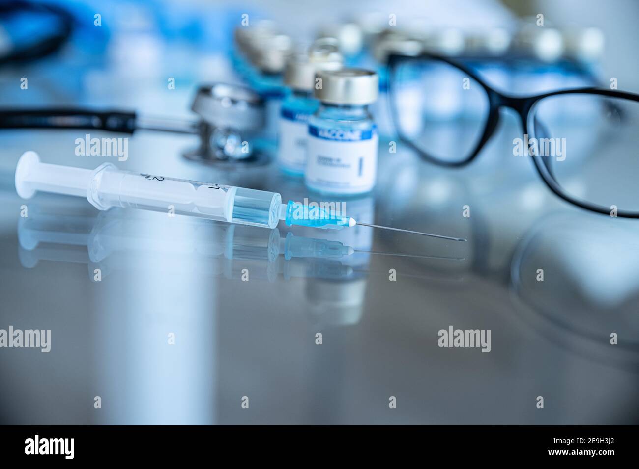 Vaccination time. Syringe and vaccine on the table in a doctor's office ...