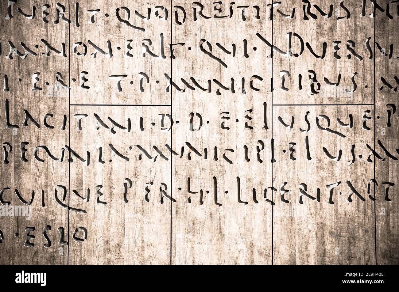 Closeup shot of a wooden surface with ancient alphabets written on it ...