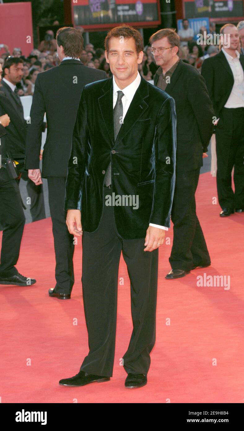 Cast member Clive Owen poses for pictures as he arrives to the premiere ...