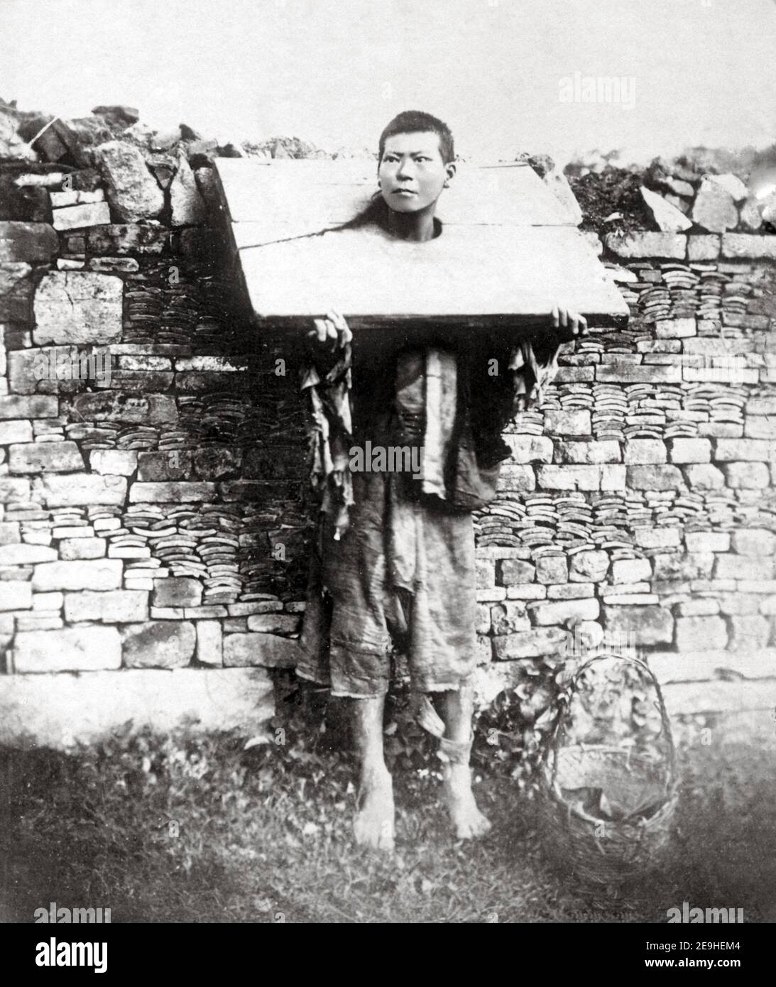 Late 19th century photograph - Man in a Cangue, stocks, punishment ...