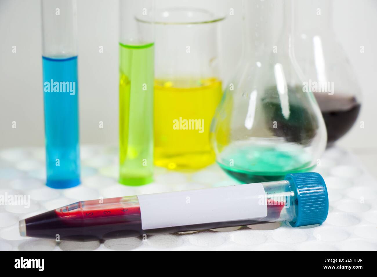 Closeup of a blood sample in a small tube on the table in the ...