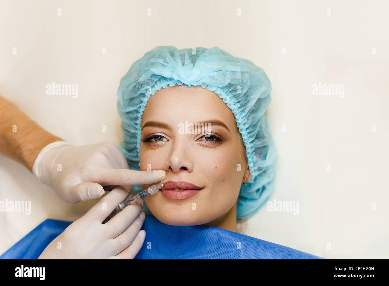 Lips augmentation injections for attractive girl. Plastic surgeon does ...