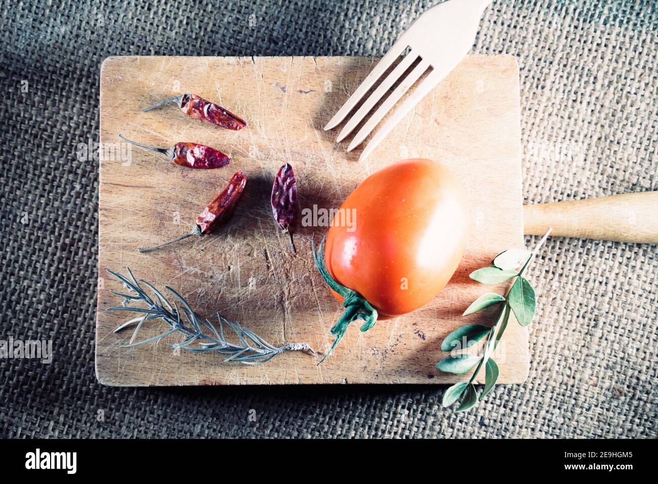 High angle shot of dried ingredients on a wooden board over textile ...
