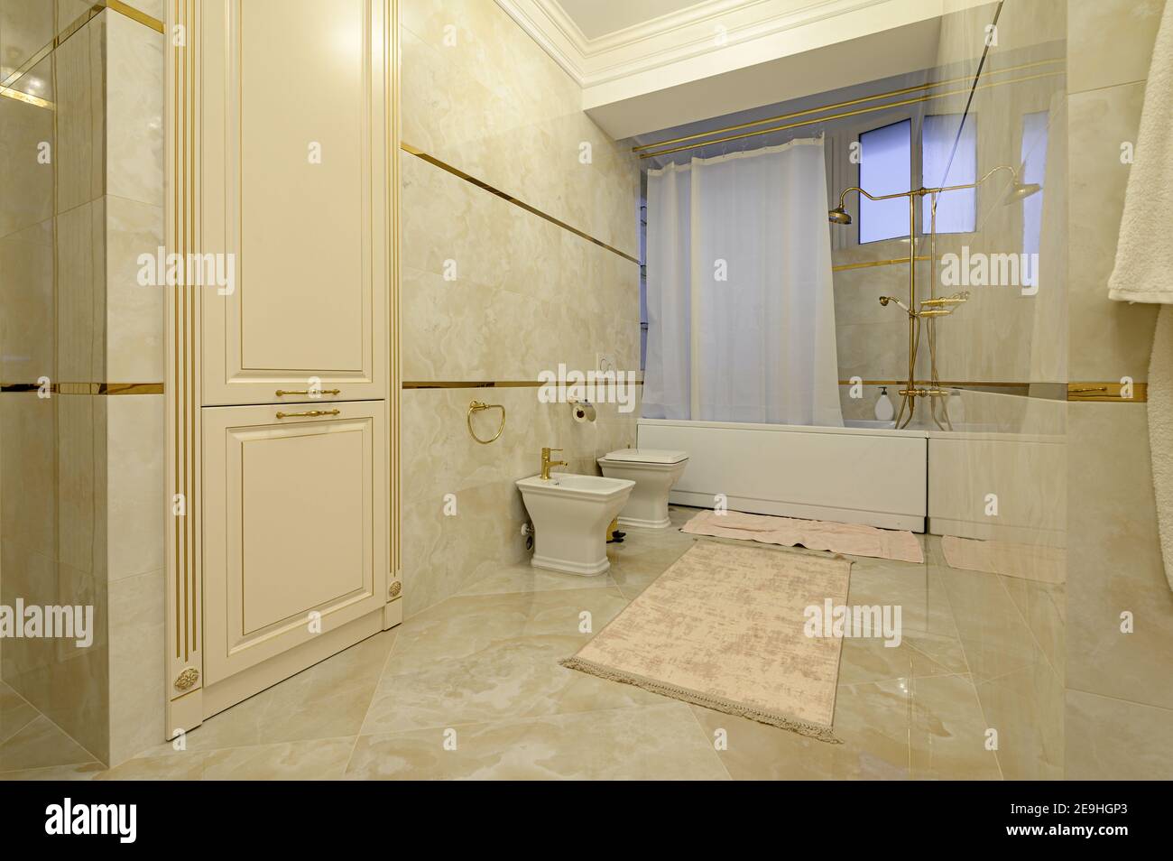 Modern luxury beige and golden bathroom with toilet Stock Photo - Alamy