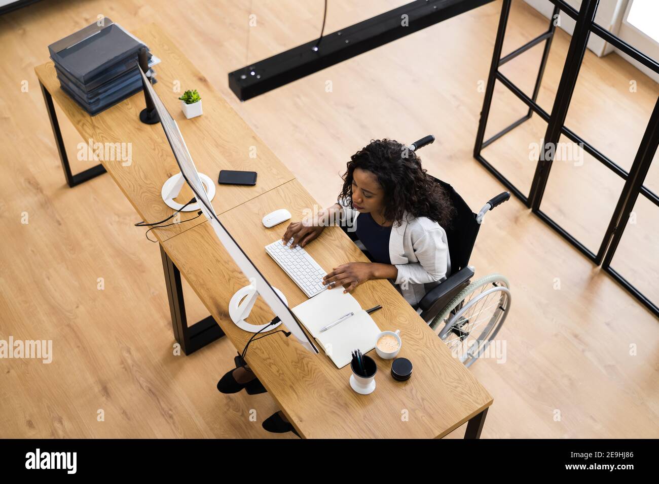 Disabled African Worker In Wheelchair Working On Computer Stock Photo ...