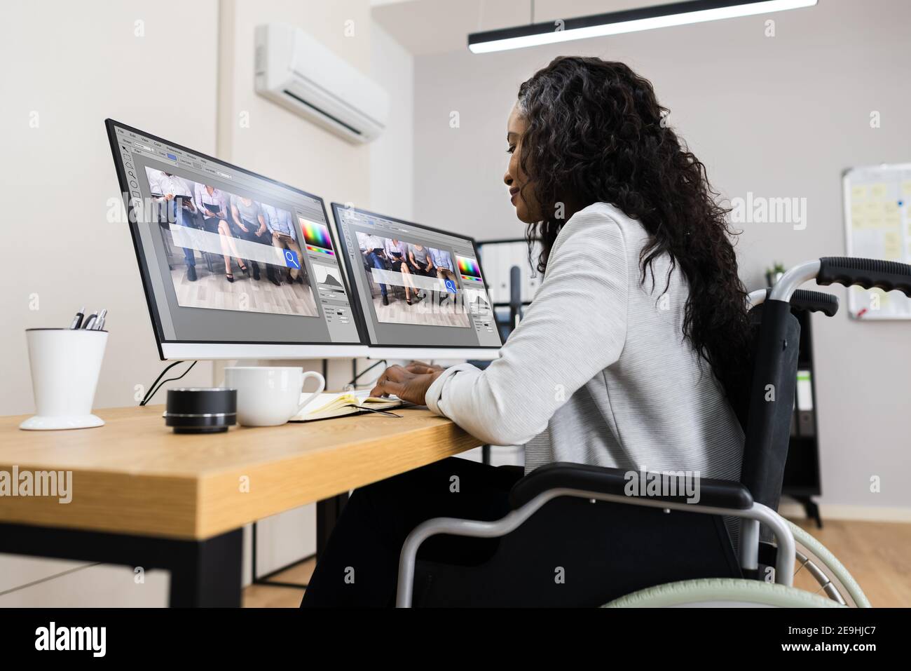 Disabled African Worker In Wheelchair Using Computer In Office Stock ...