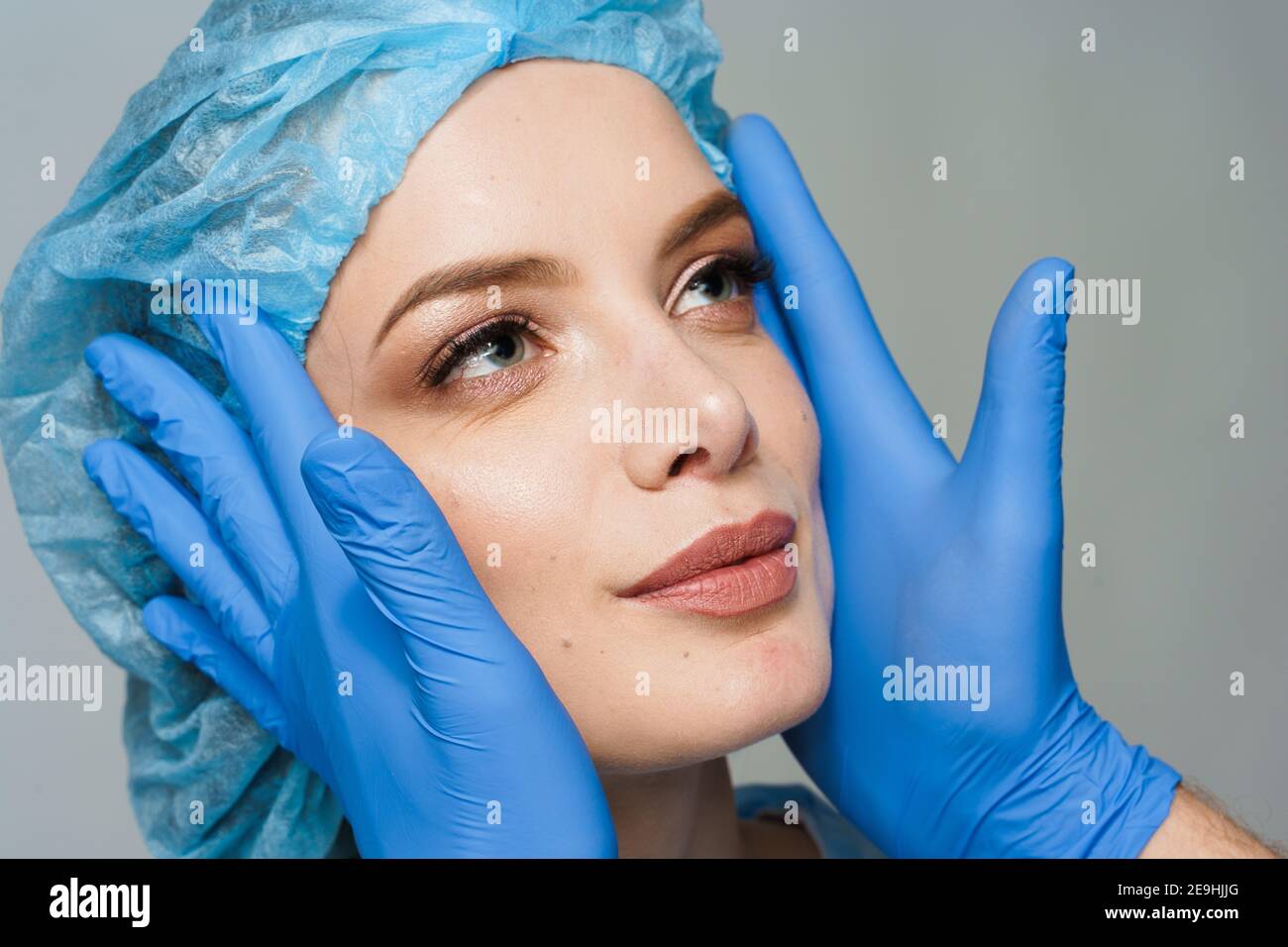 Consultation with plastic surgeon on white background. Cosmetic ...