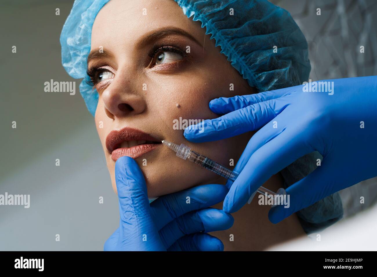 Lips augmentation injections for attractive girl on white background ...