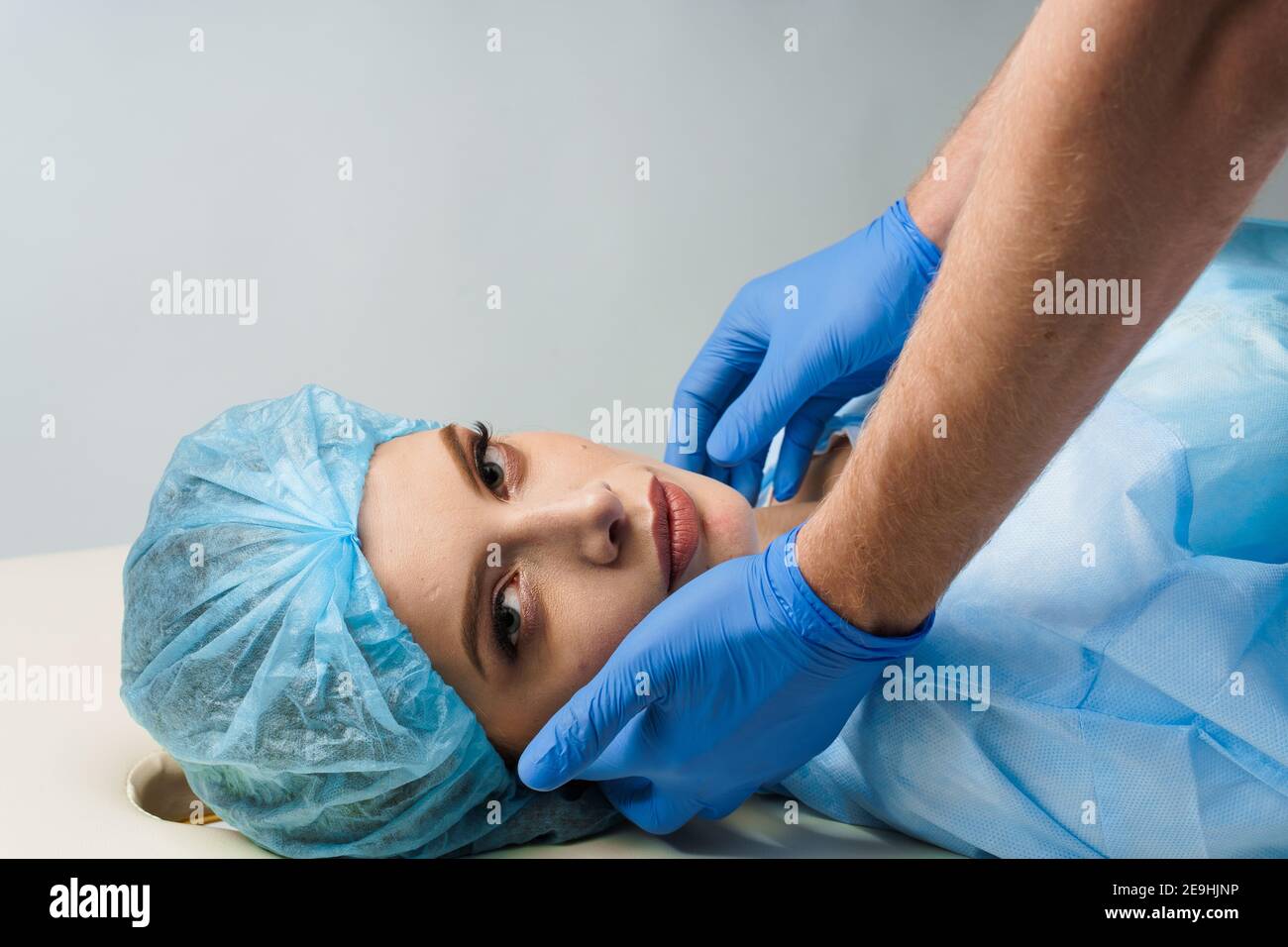 Consultation with plastic surgeon on white background. Cosmetic ...