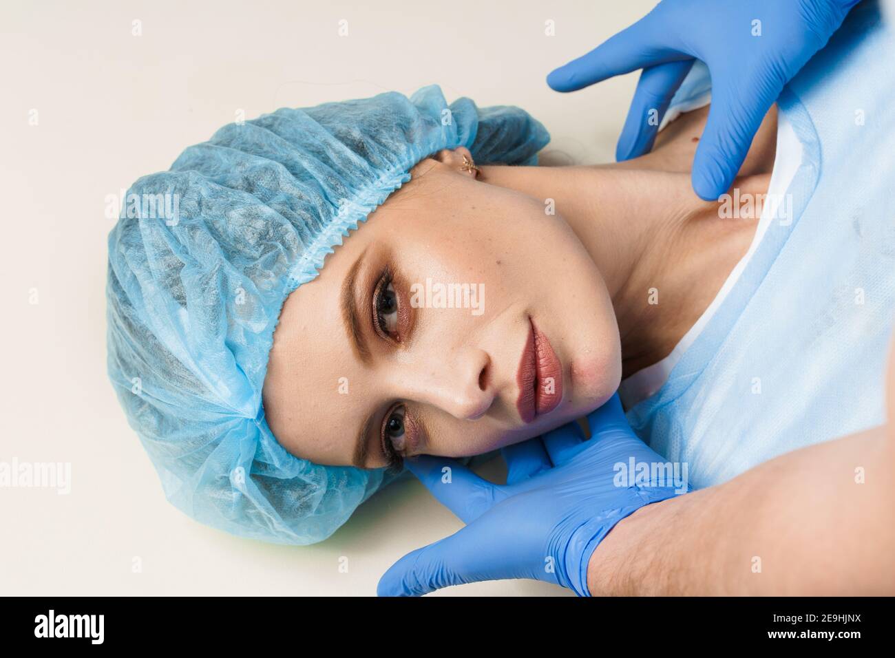 Consultation with plastic surgeon on white background. Cosmetic ...