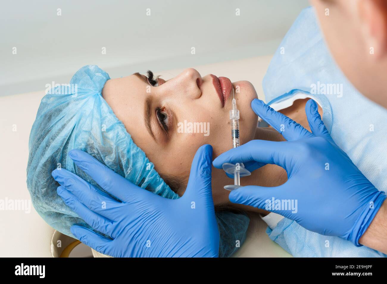 Lips augmentation injections for attractive girl on white background ...