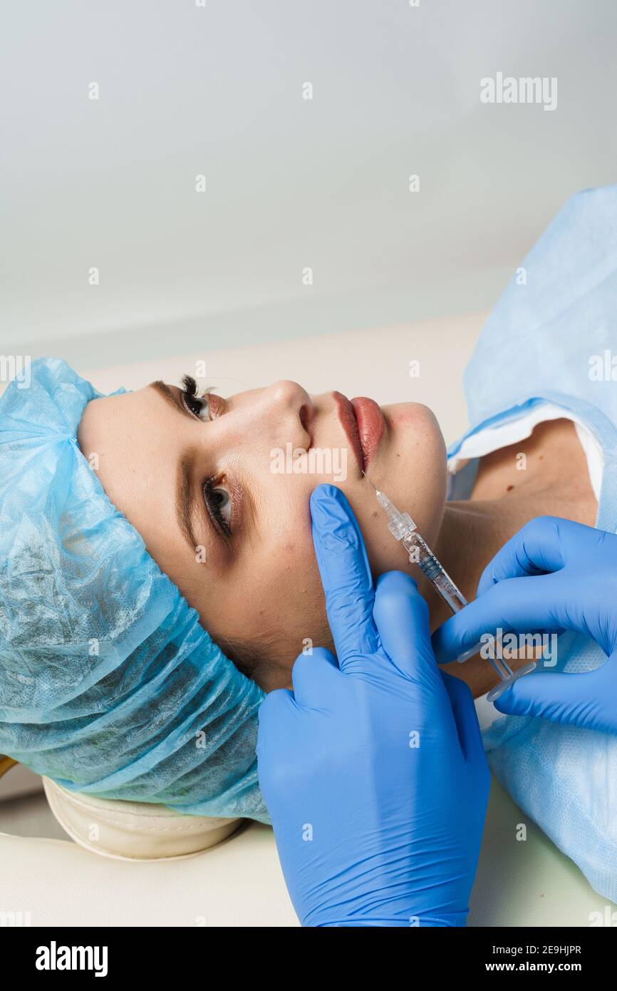 Lips augmentation injections for attractive girl on white background ...