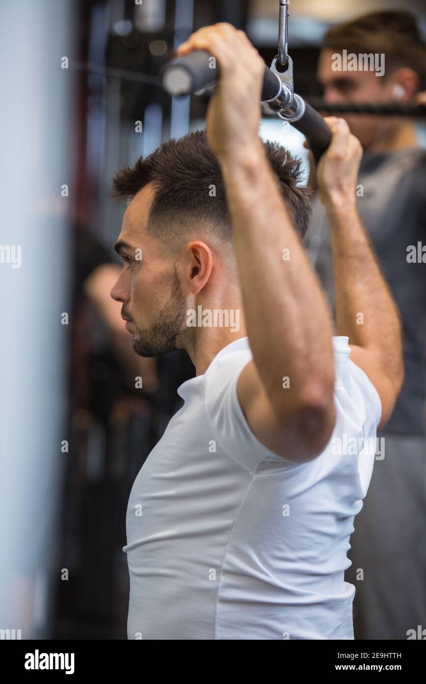 handsome man lifting barbel Stock Photo - Alamy