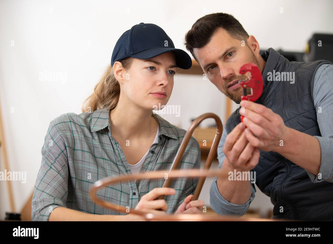 man and woman cooper pipe welding soldering Stock Photo - Alamy