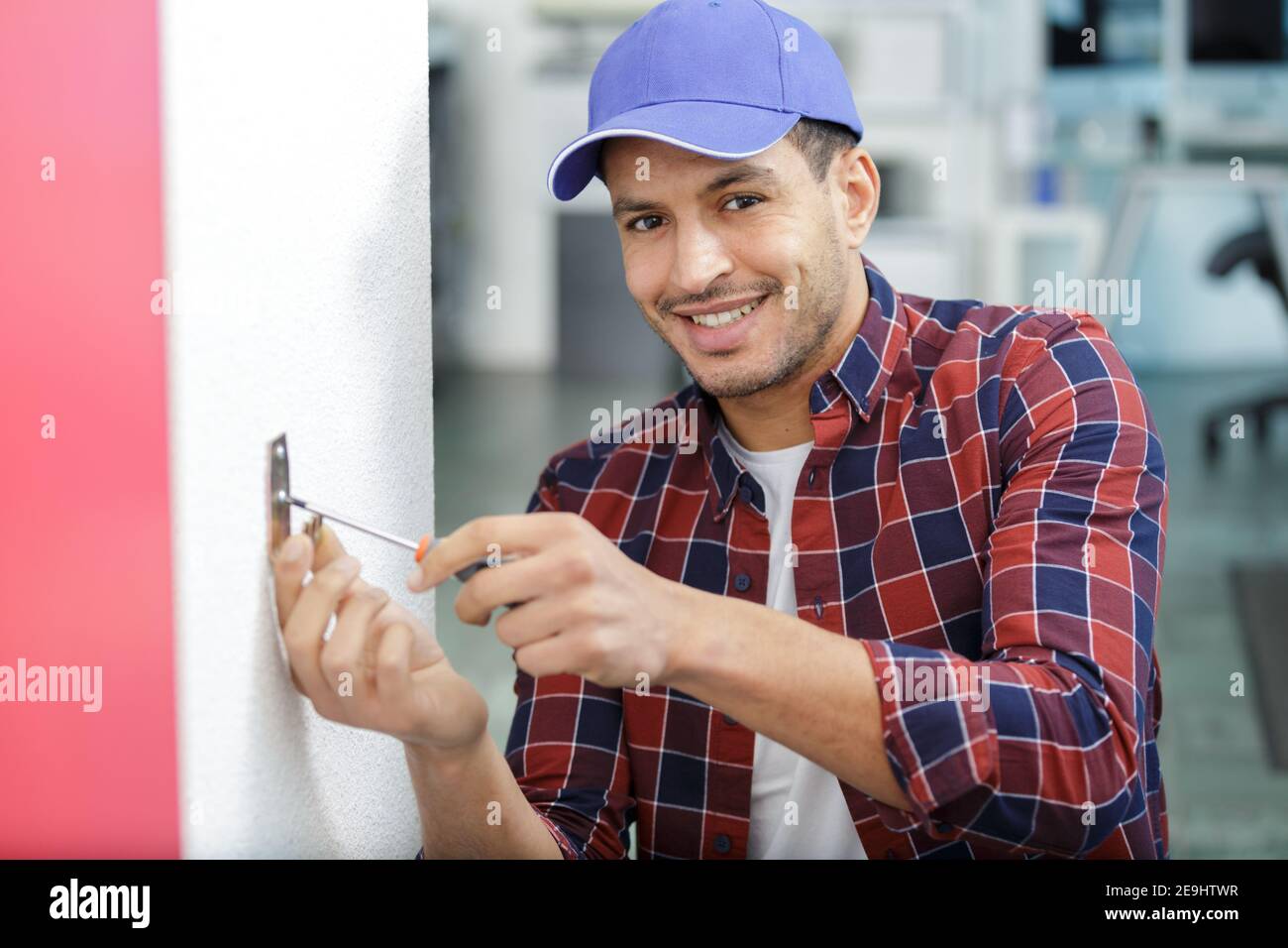 service man installing power socket in wall with screwdriver Stock ...