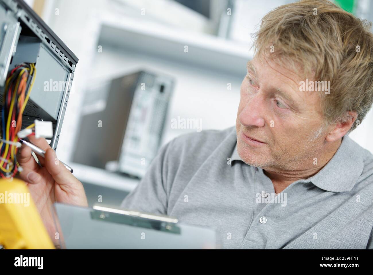 portrait of an electronic engineer fixing a pc Stock Photo - Alamy