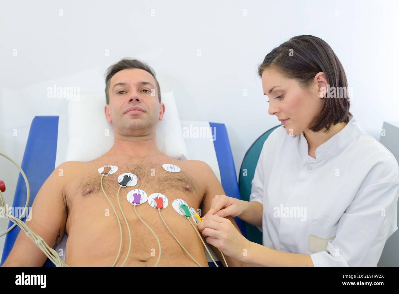 nurse putting the cardiogram electrodes on patients body Stock Photo ...