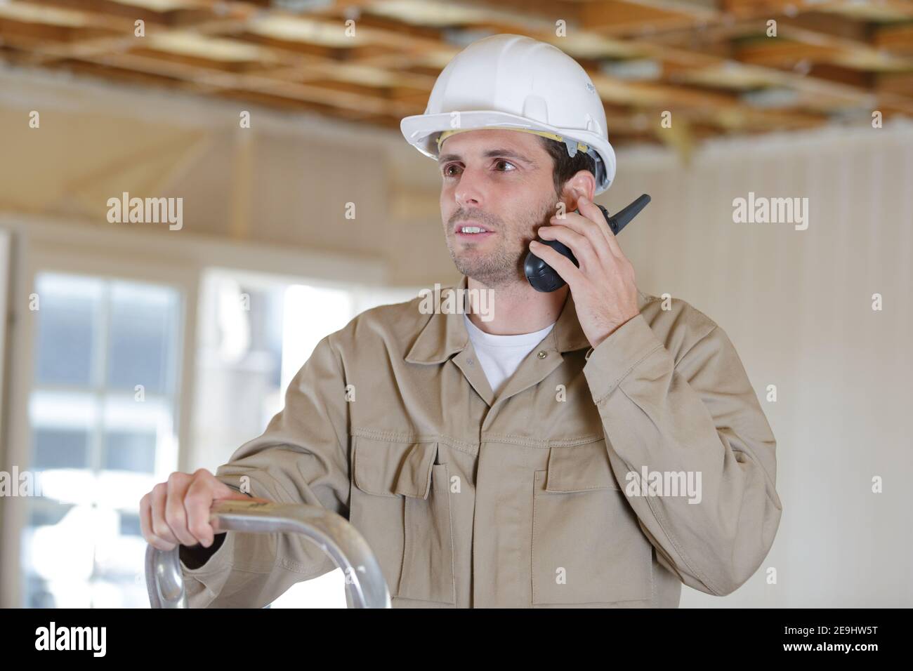 a worker using walkie talkie Stock Photo - Alamy