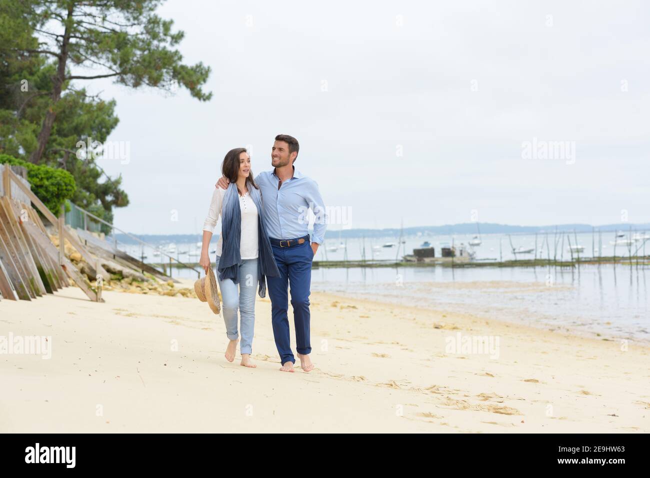 happy romantic couple walking on beach Stock Photo - Alamy
