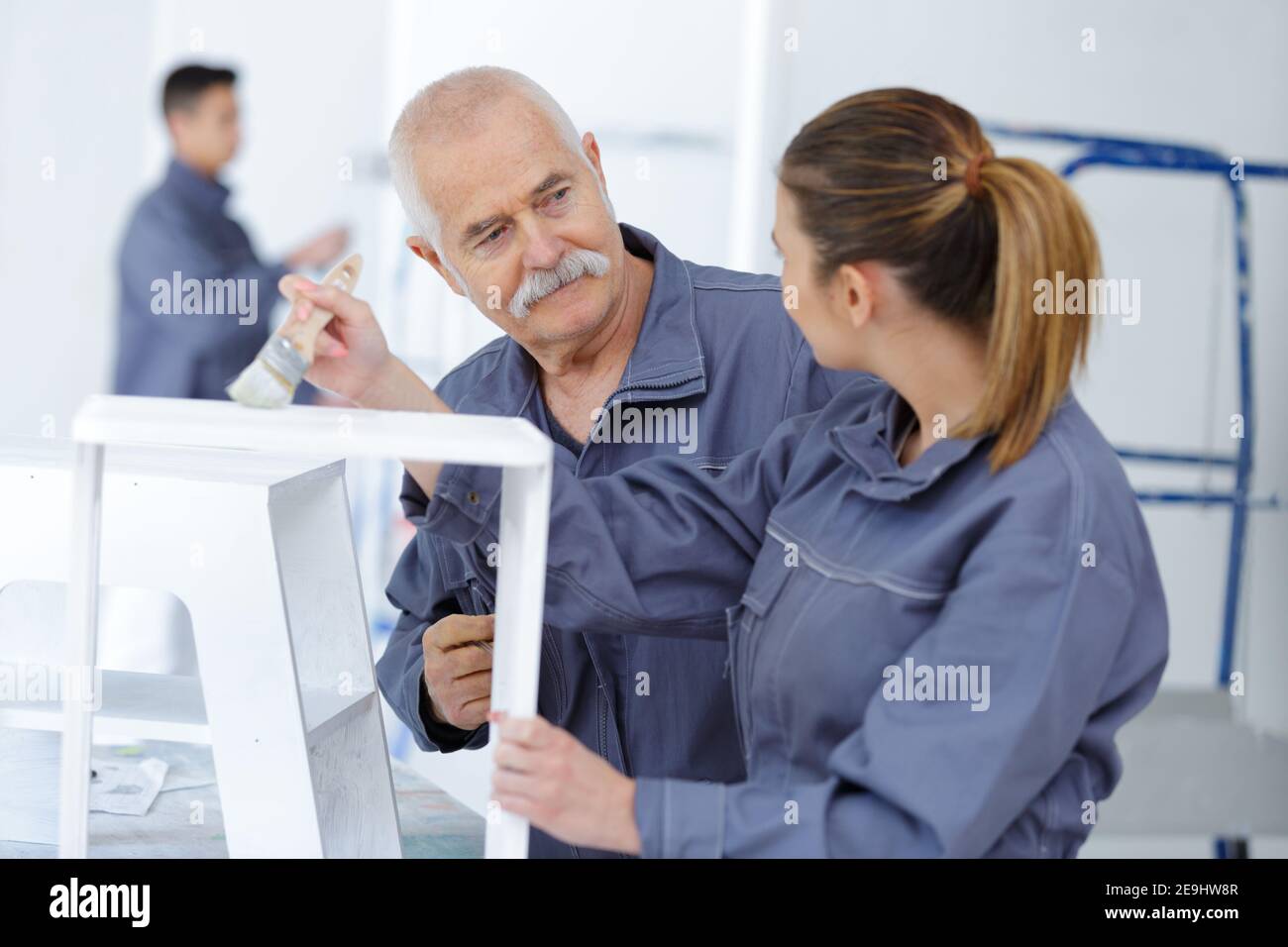portrait of team during painting training Stock Photo - Alamy