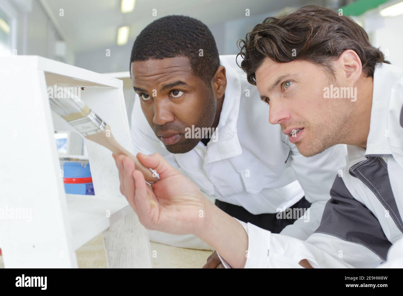 close up of painter with apprentice Stock Photo - Alamy
