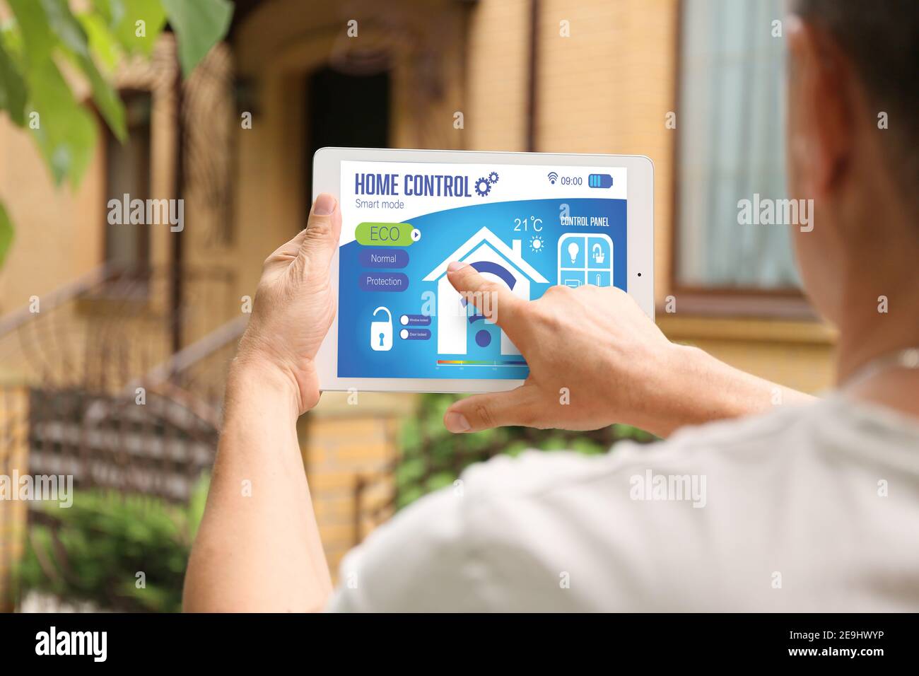 Man using application of smart home automation near house outdoors ...