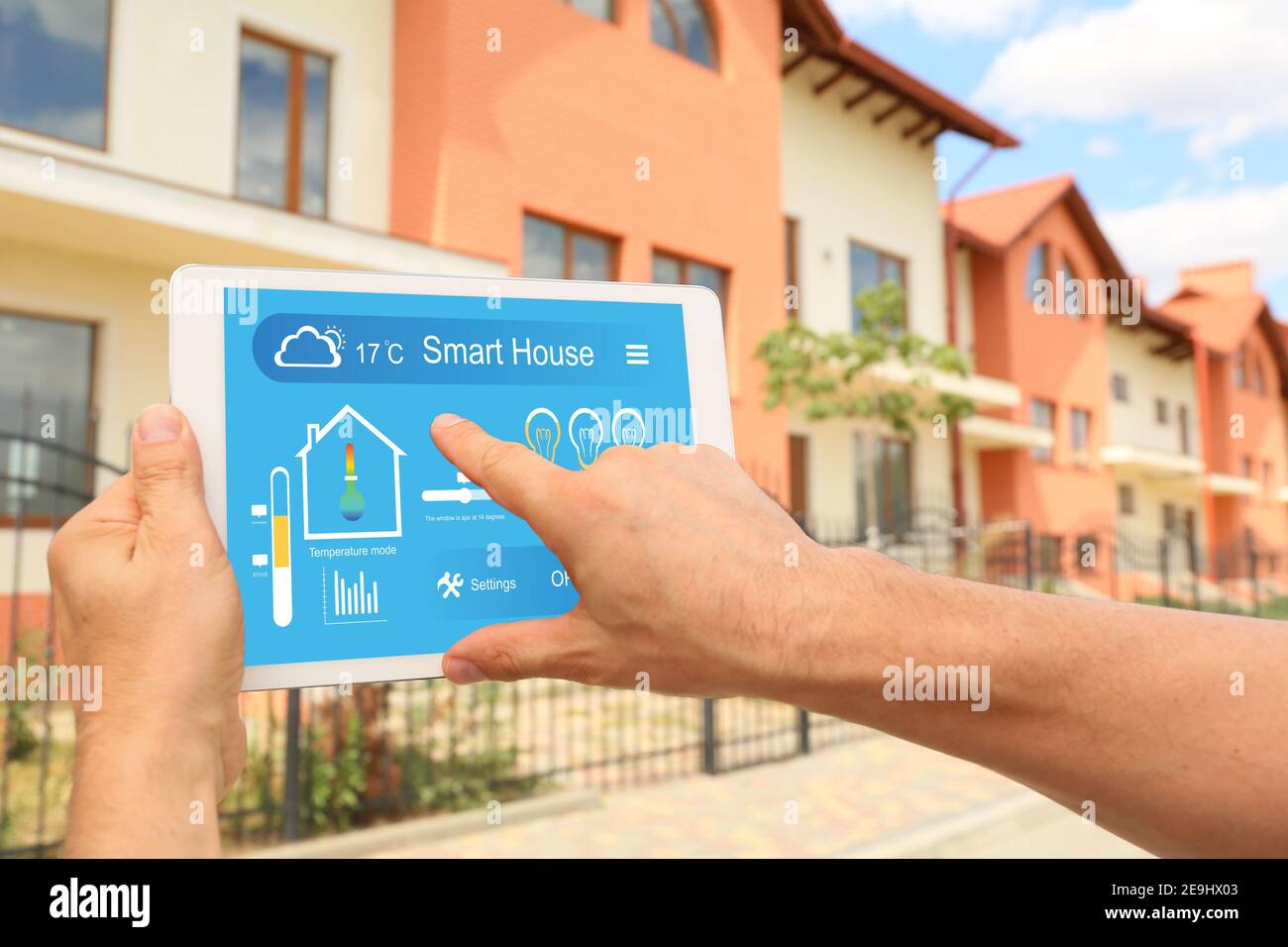 Man using application of smart home automation near house outdoors ...