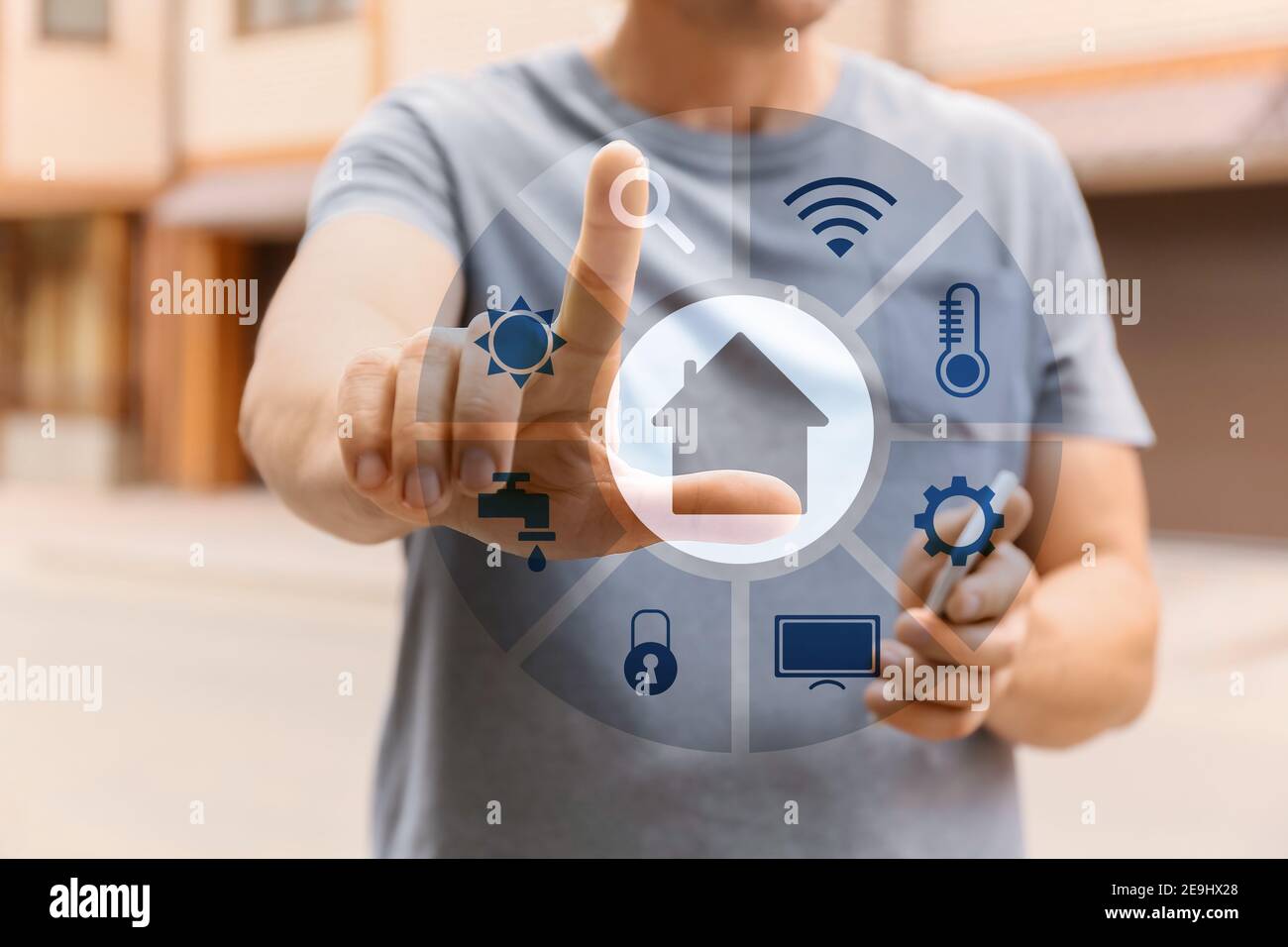 Man using application of smart home automation outdoors Stock Photo - Alamy