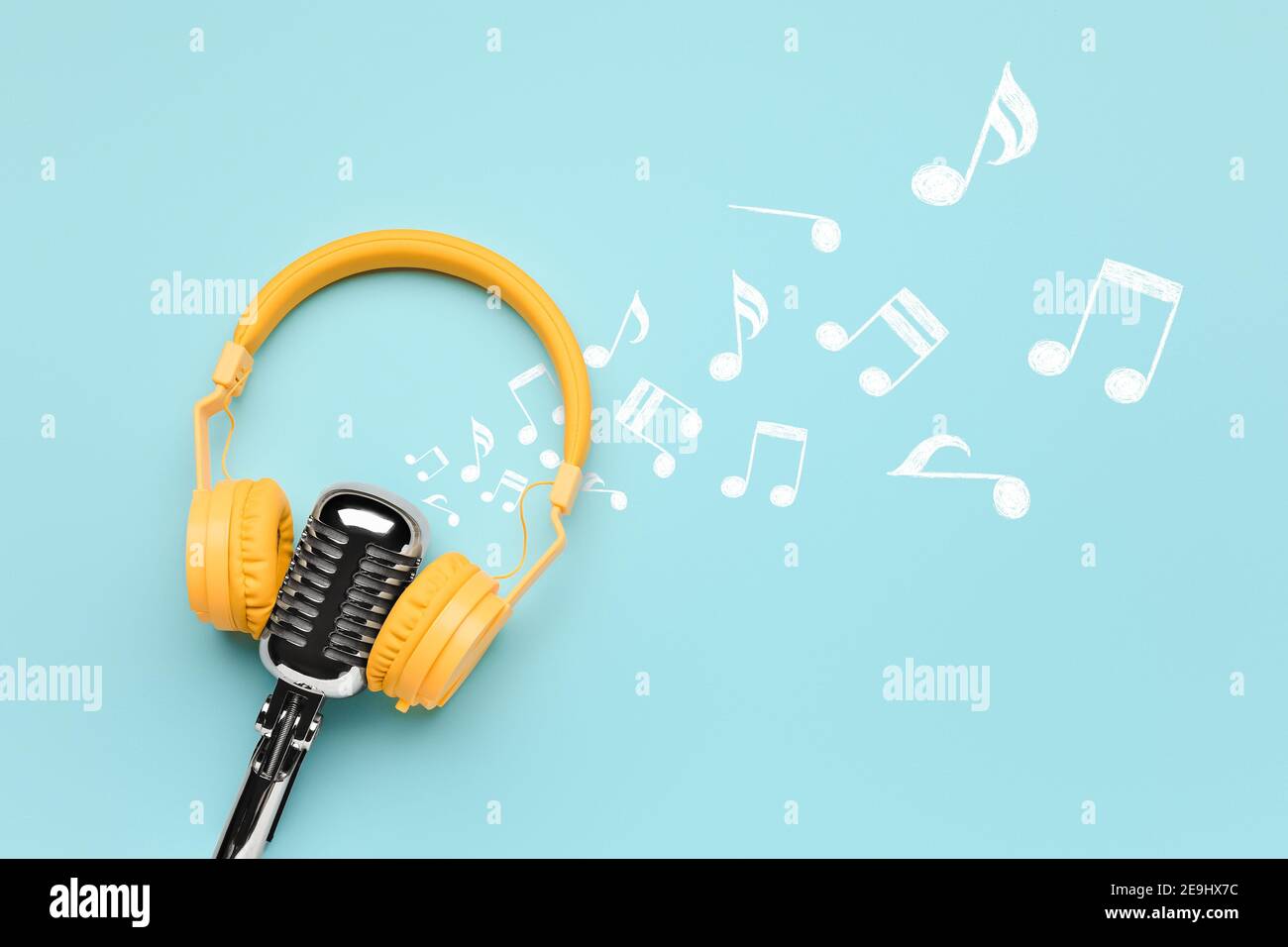 Headphones with microphone and flying music notes on color background ...