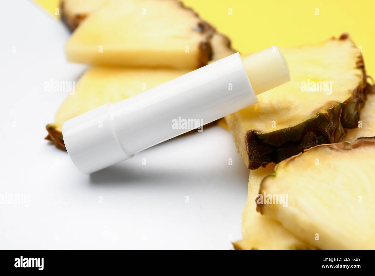 Natural lip balm with pineapple on white background Stock Photo - Alamy