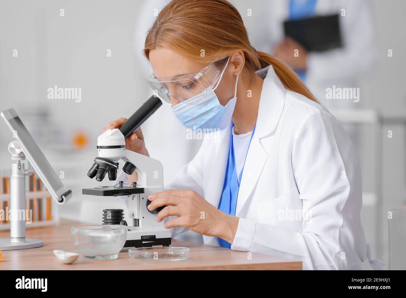 Female scientist working with microscope in laboratory Stock Photo - Alamy