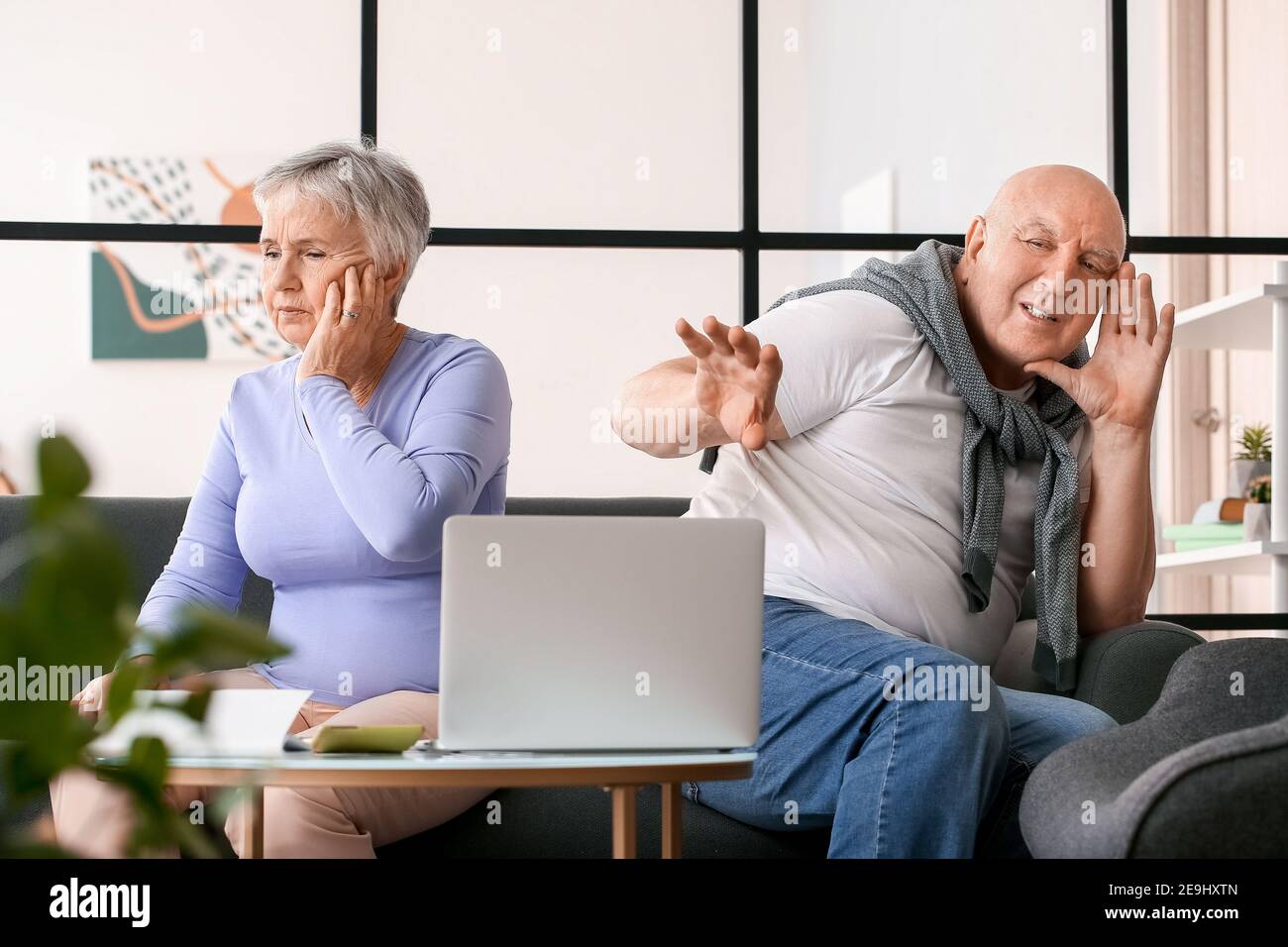 Stressed senior couple with laptop at home Stock Photo - Alamy