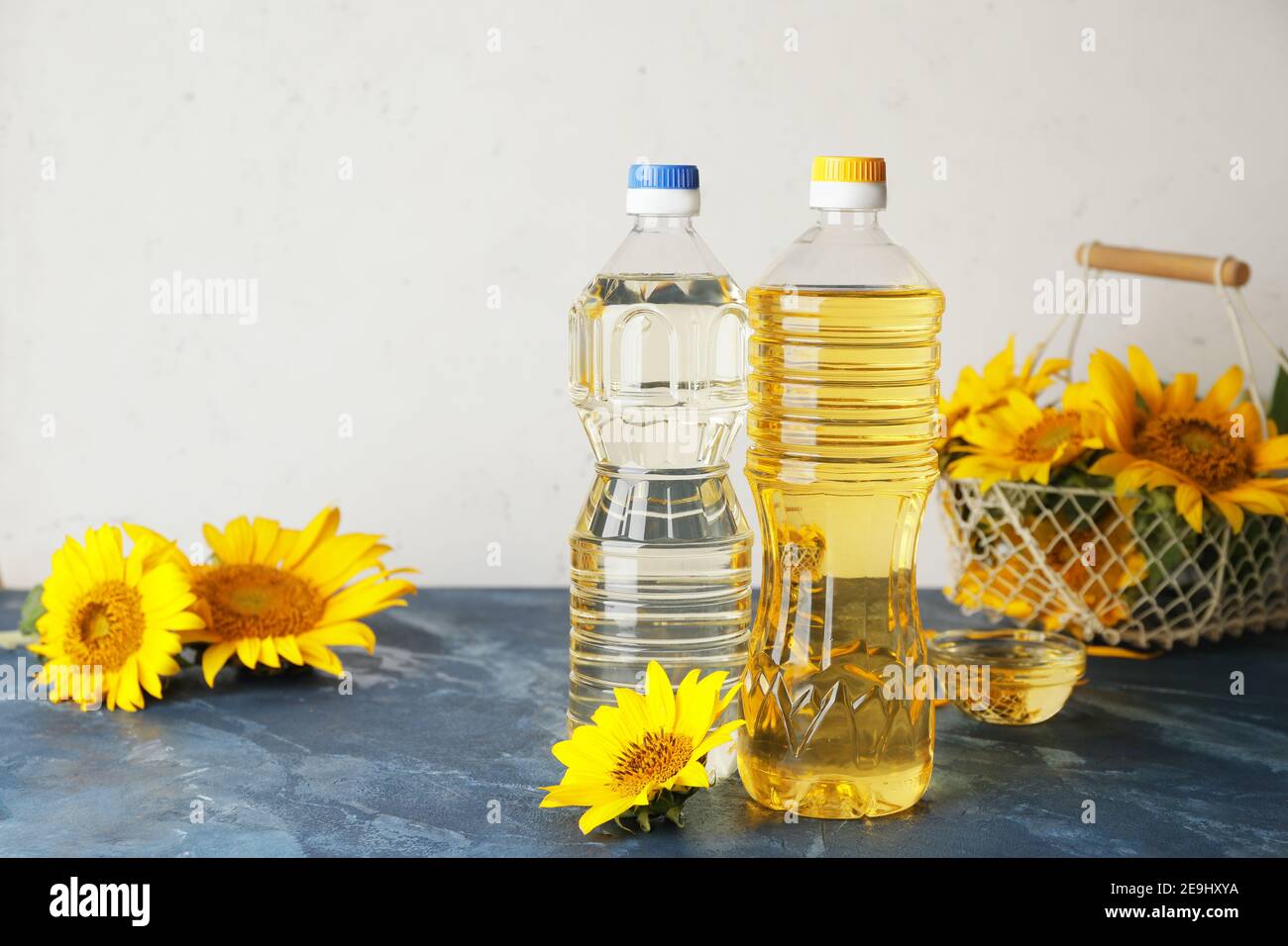 Plastic bottles of sunflower oil on color background Stock Photo - Alamy