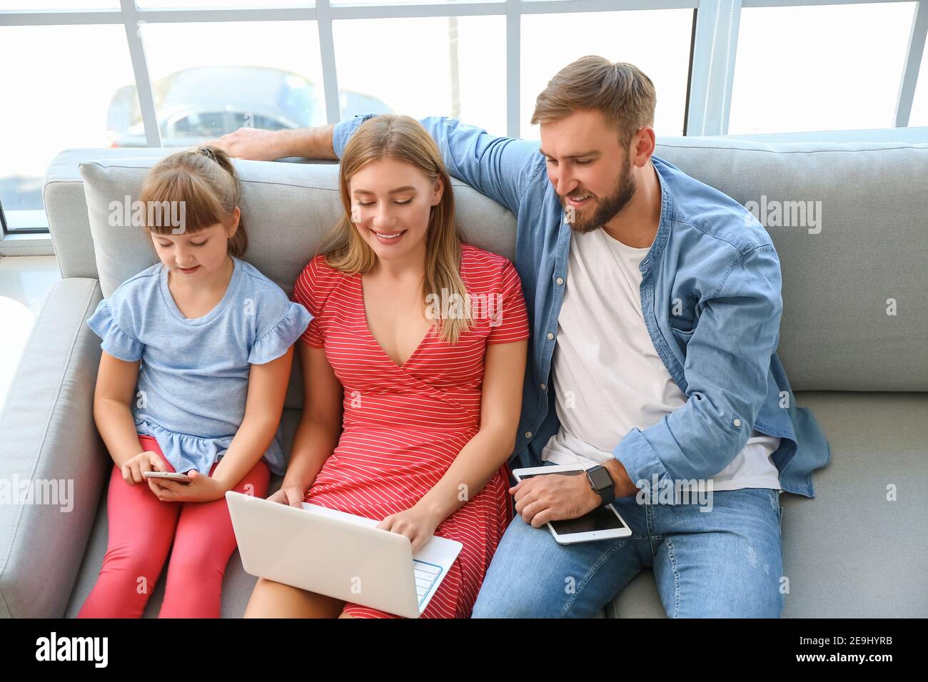 Happy family with modern devices at home Stock Photo - Alamy