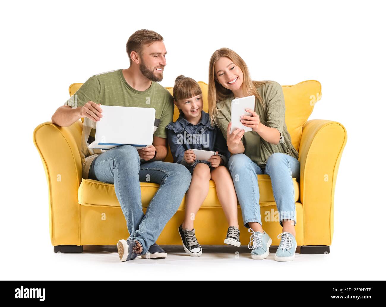 Happy family with gadgets on sofa against white background Stock Photo ...