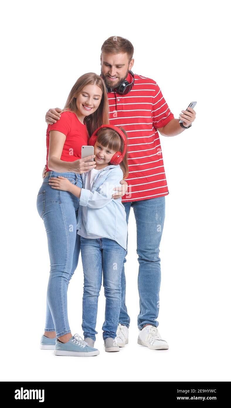 Happy family with mobile phones and headphones on white background ...
