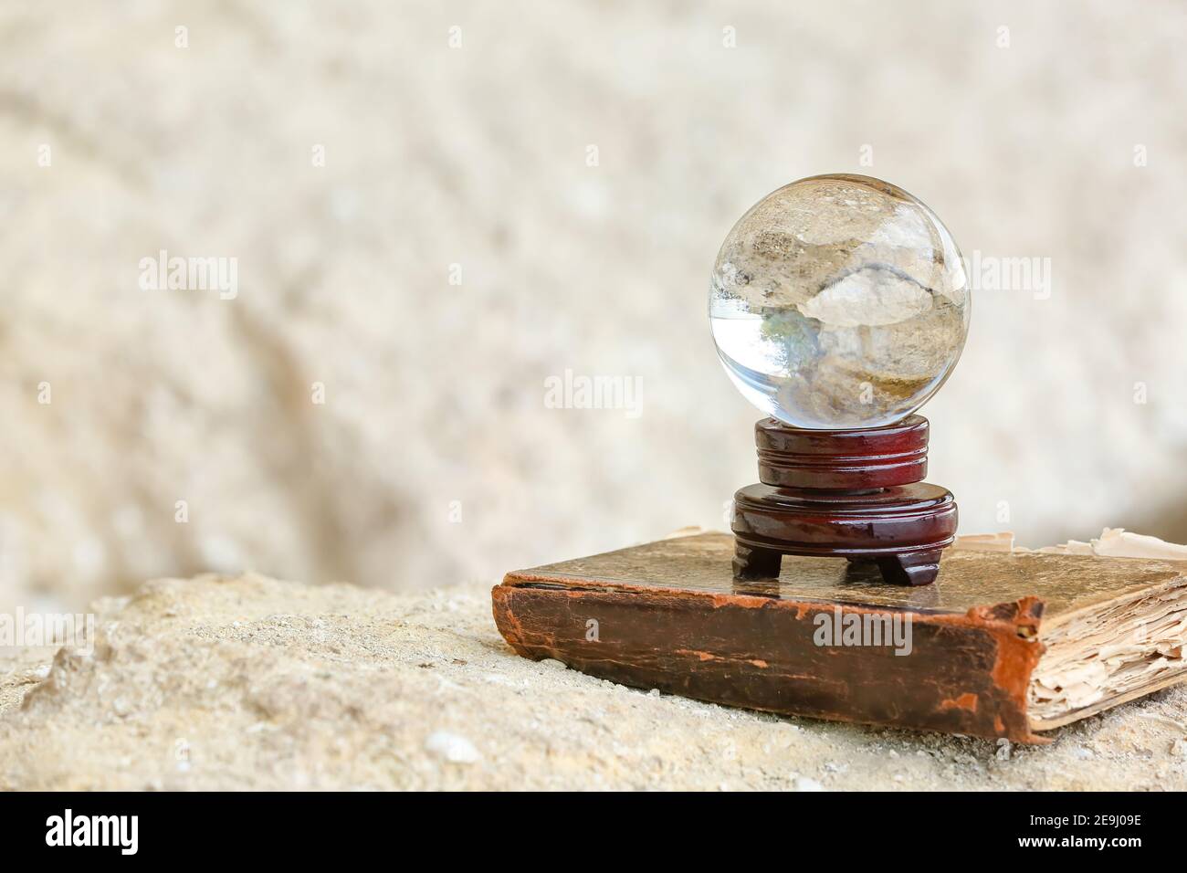 Crystal ball of fortune teller and spell book outdoors Stock Photo - Alamy