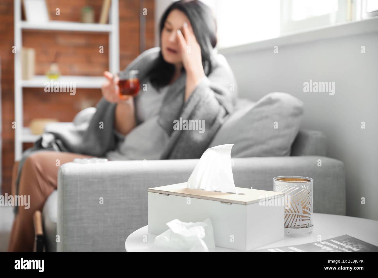 Tissues on table of sick mature woman Stock Photo - Alamy