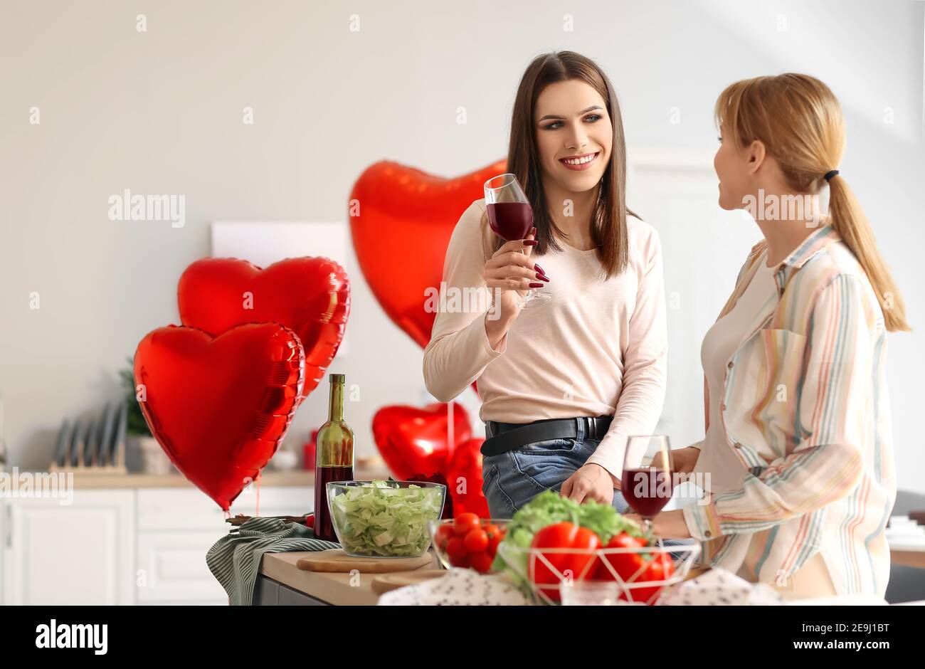 Happy transgender couple celebrating Valentine's Day while cooking ...