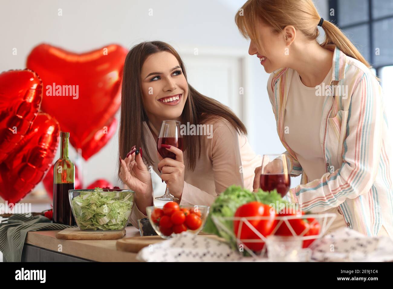 Happy transgender couple celebrating Valentine's Day while cooking ...
