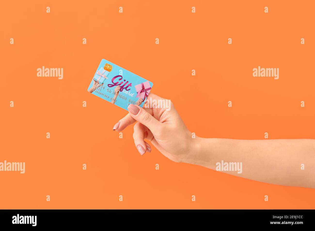 Female hand with gift card on color background Stock Photo - Alamy