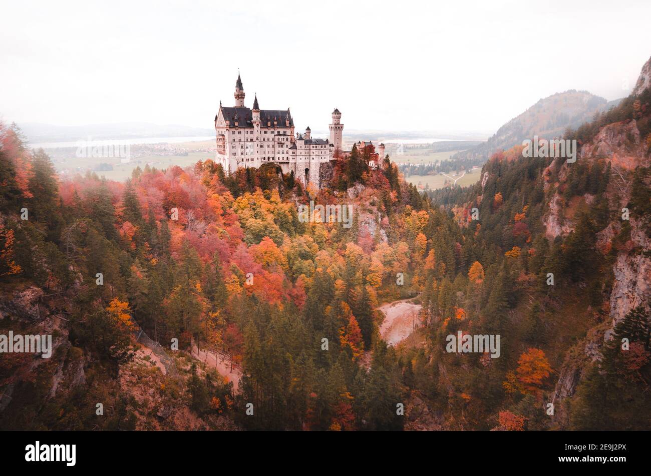 Mesmerizing view of the Neuschwanstein Castle on a hill with autumn ...