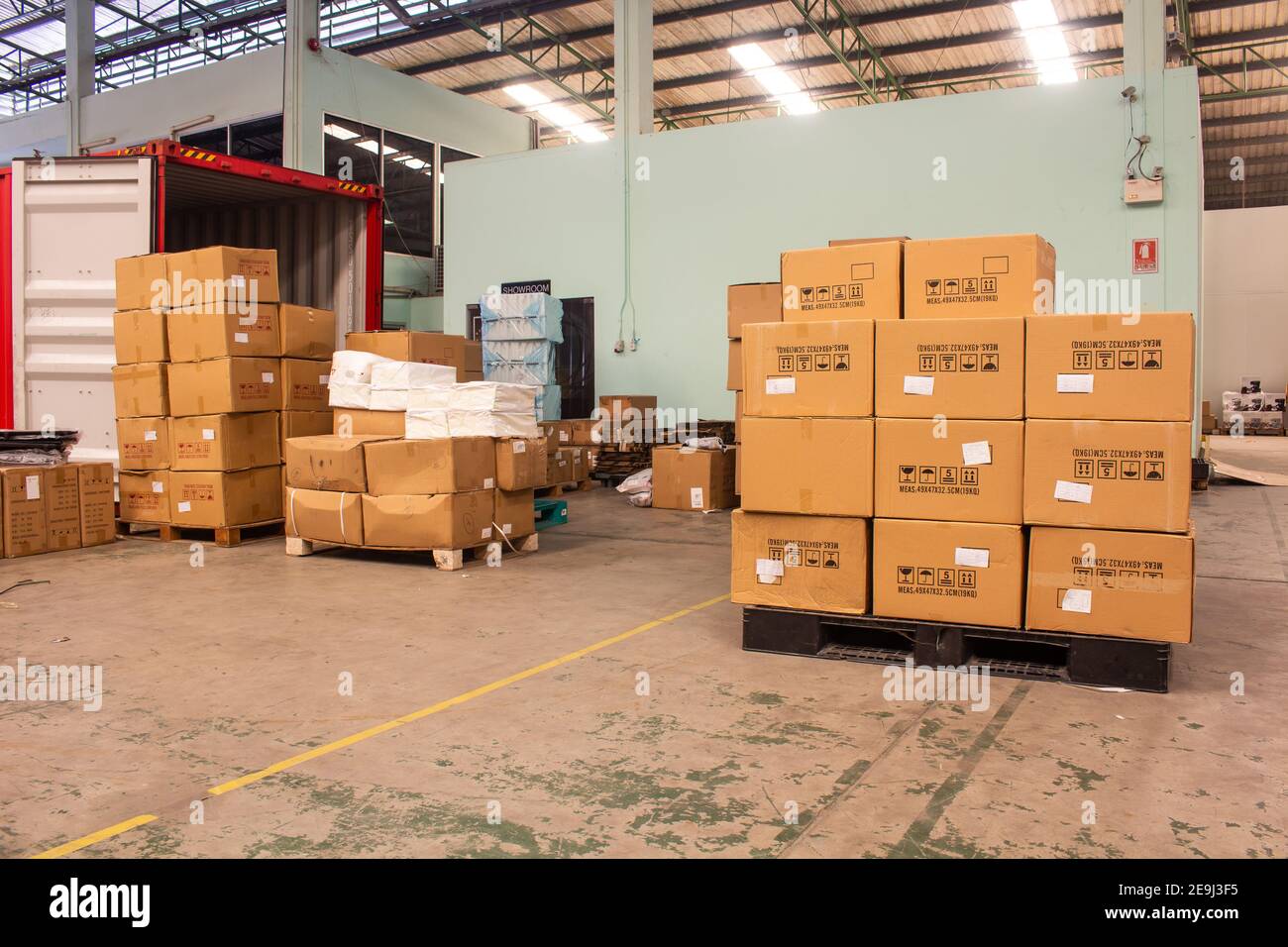 The cartons with loading out of container Stock Photo - Alamy