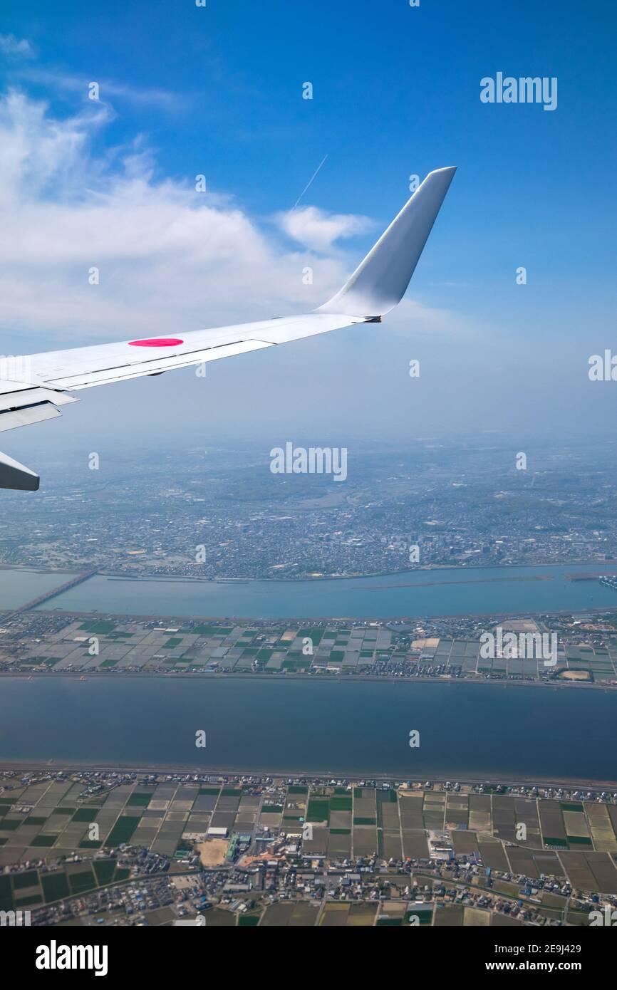 Japanese airplane wing over Nagashima, Nagoya city in Japan. Aerial ...